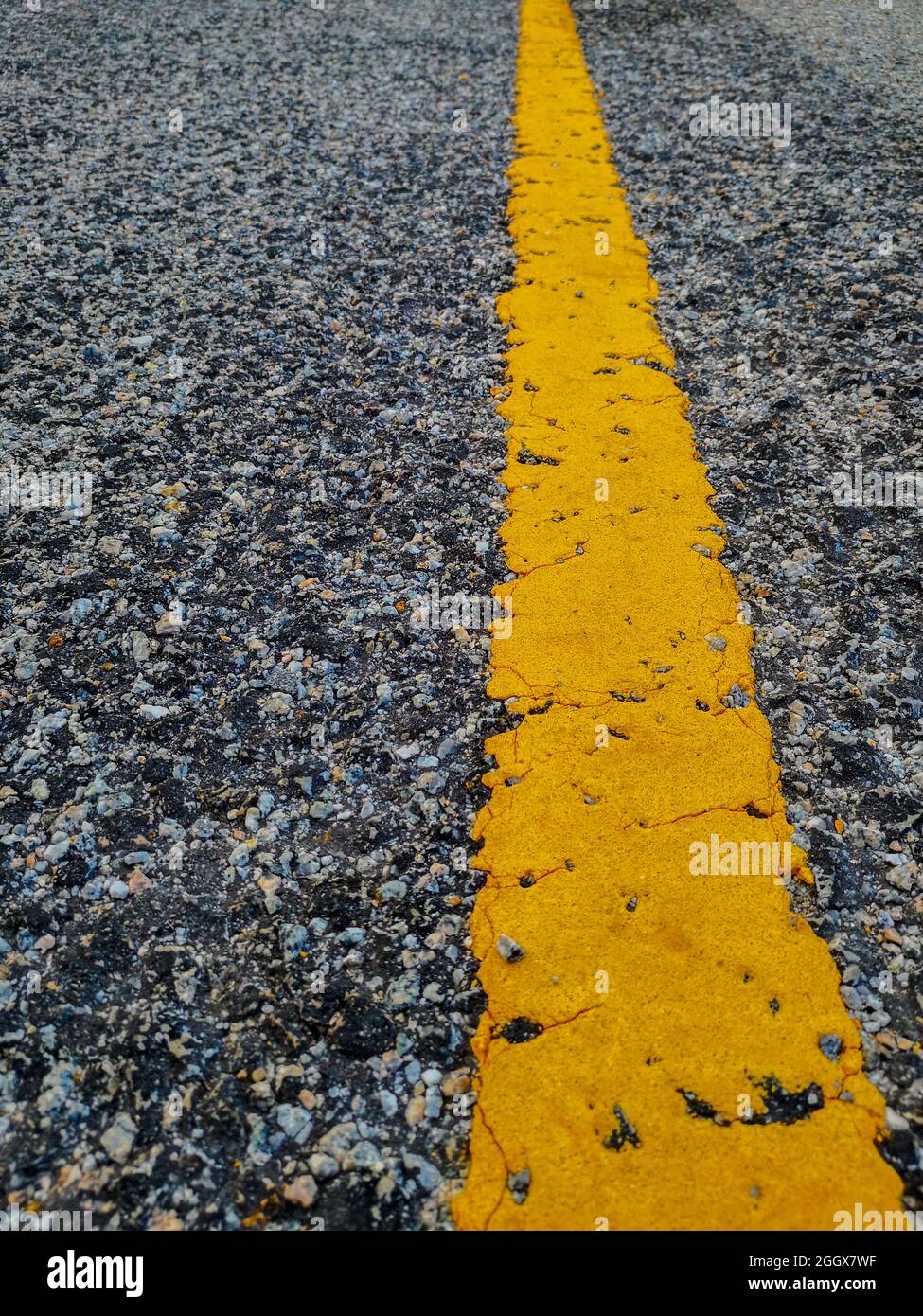 yellow line wiht asphalt road texture. close up Stock Photo - Alamy