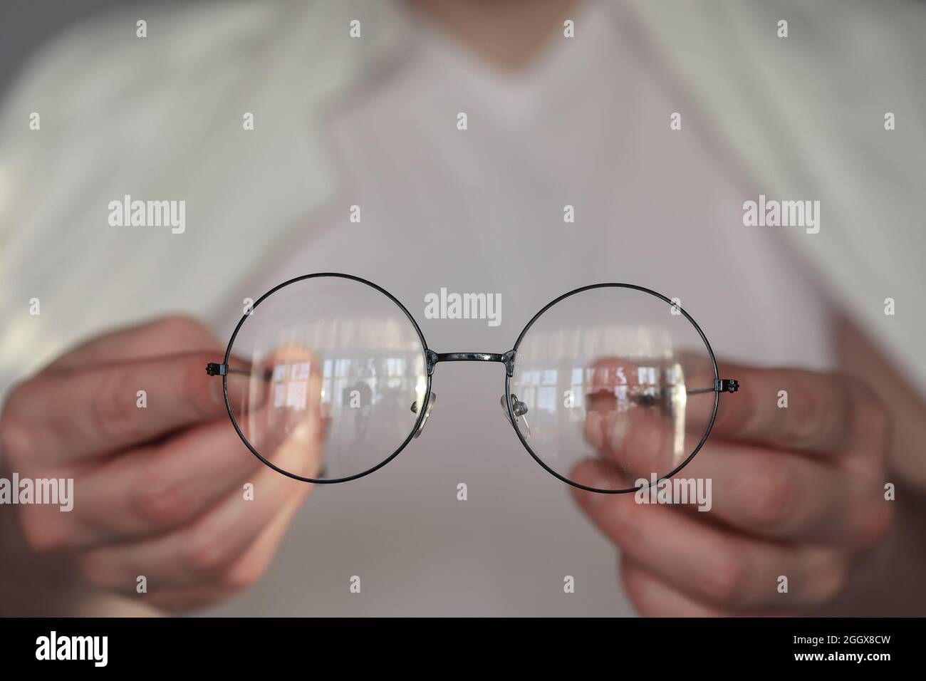 The concept of poor vision. Hold a contact lens and glasses in hand ...
