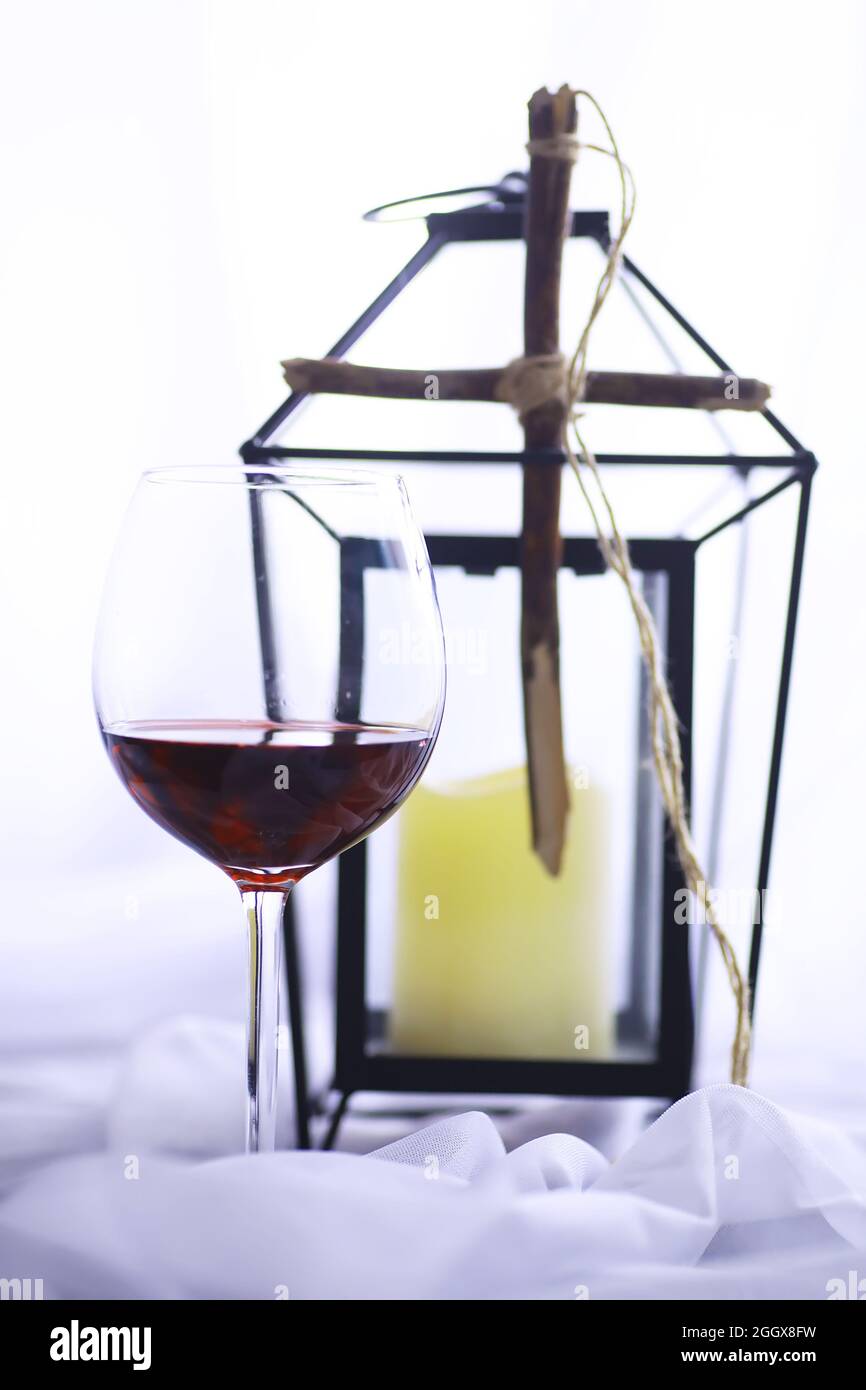 Religious concept. Handmade wooden cross on a white background. Wine ...