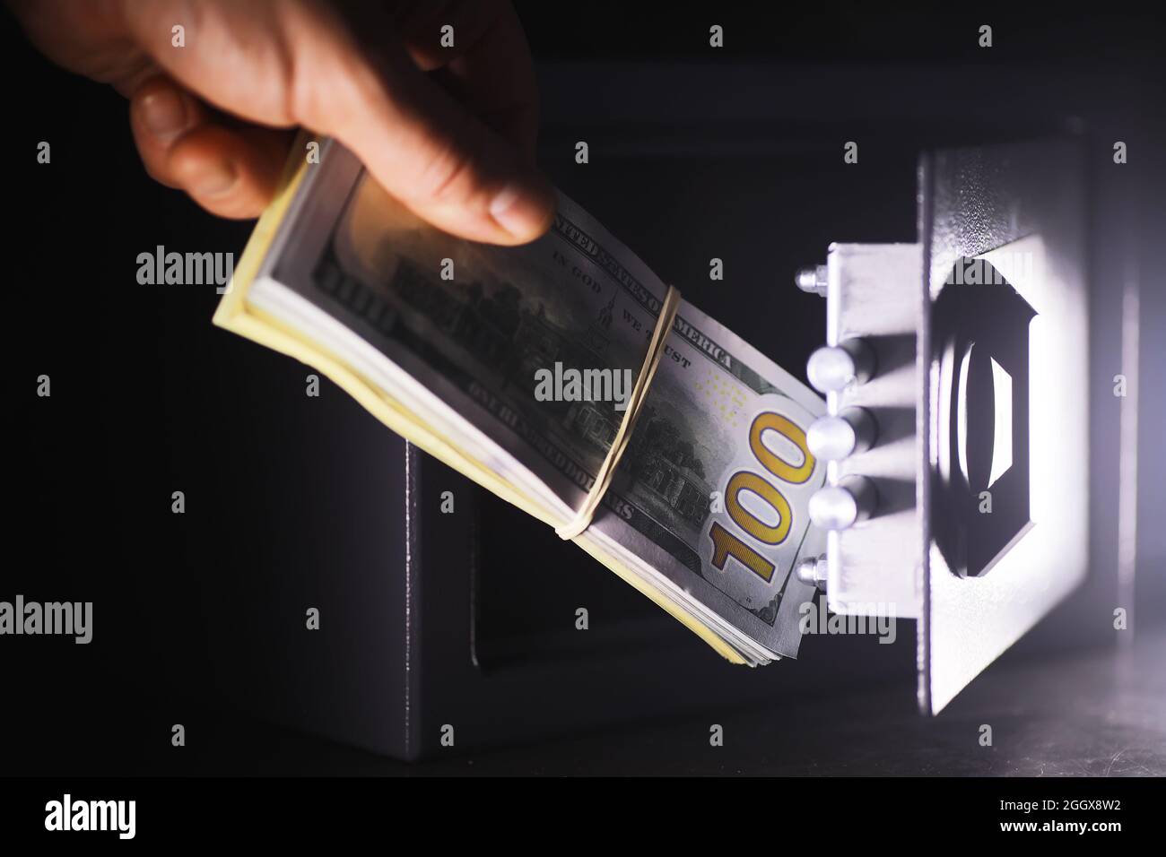 Steel safe with money. Hand putting password in the safety money box in ...