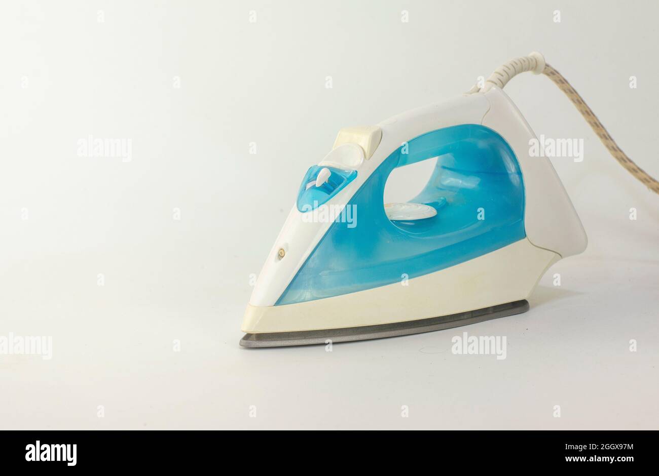 Closeup shot of a blue-white iron isolated on a white background Stock ...