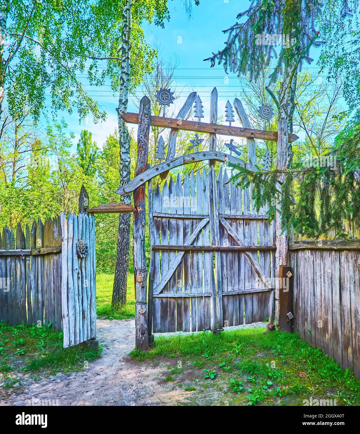 The palisade and the wooden gate of ancient Slavic estate, decorated ...