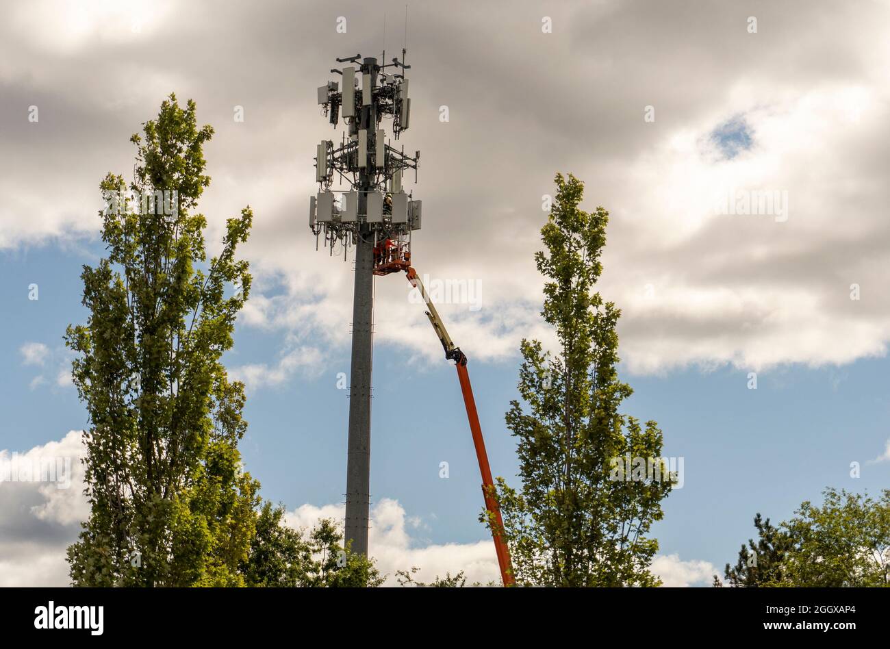 A cell tower being repaired Stock Photo - Alamy