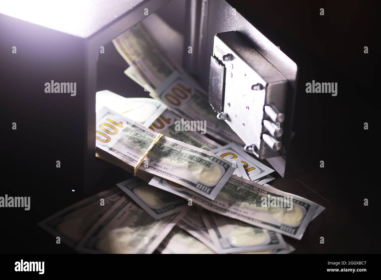 Steel safe with money. Hand putting password in the safety money box in ...