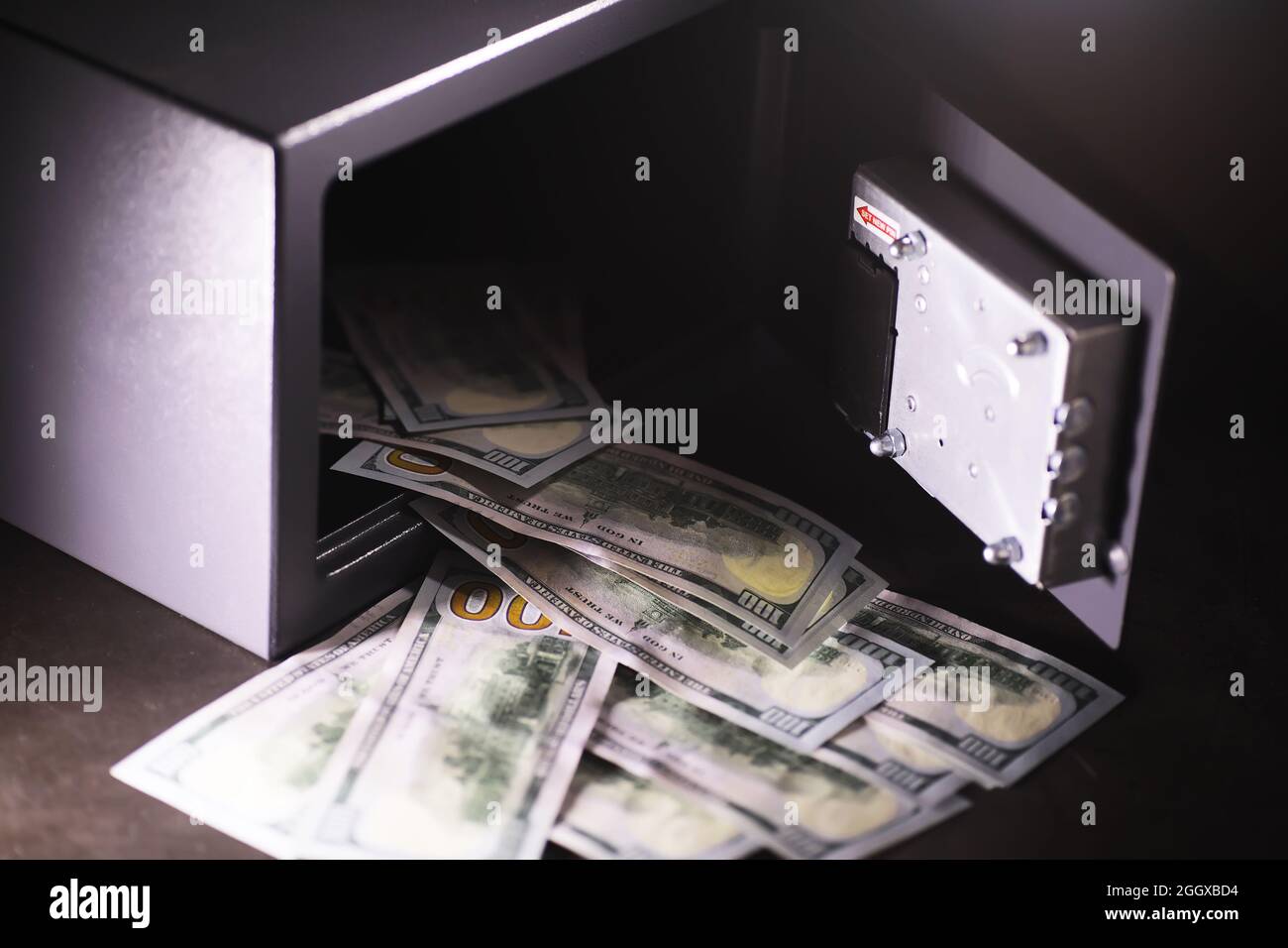 Steel safe with money. Hand putting password in the safety money box in ...