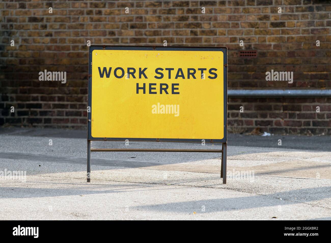 Work starts here road workers sign Stock Photo - Alamy