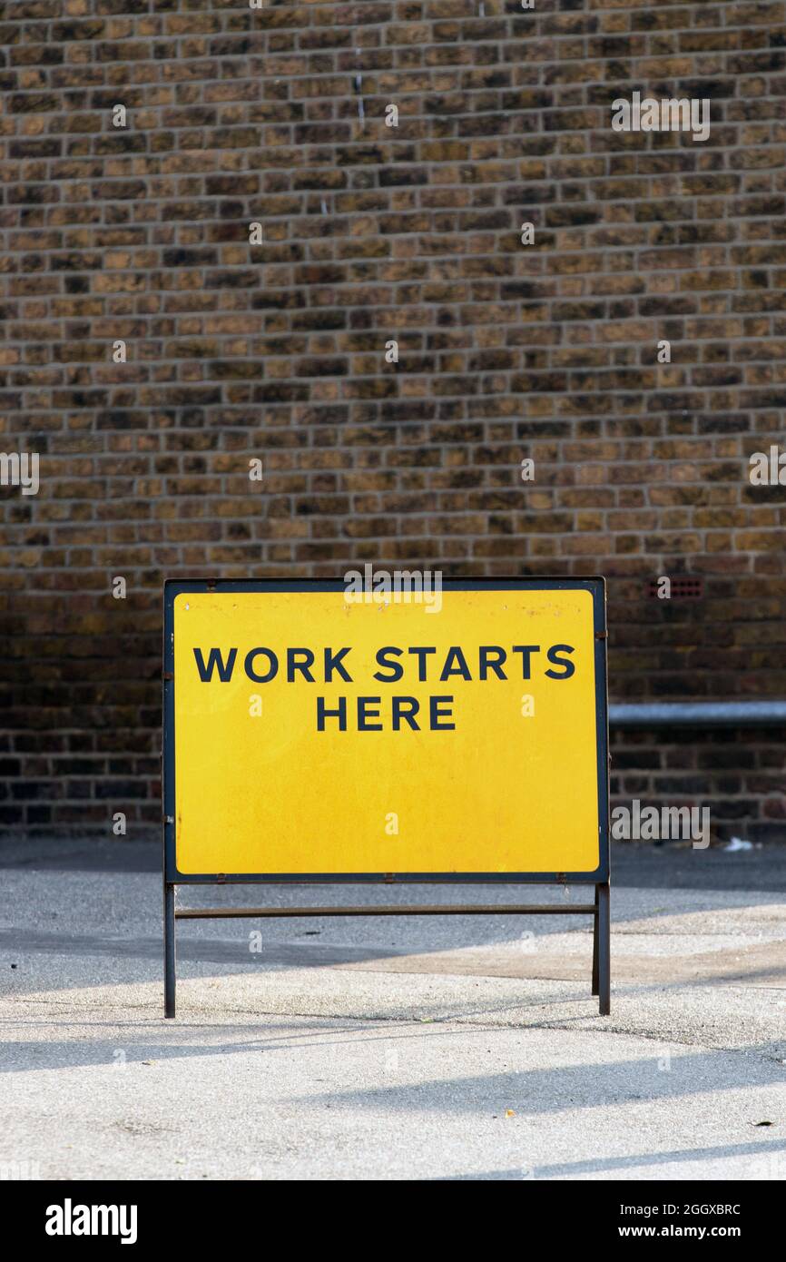 Work starts here road workers sign Stock Photo - Alamy