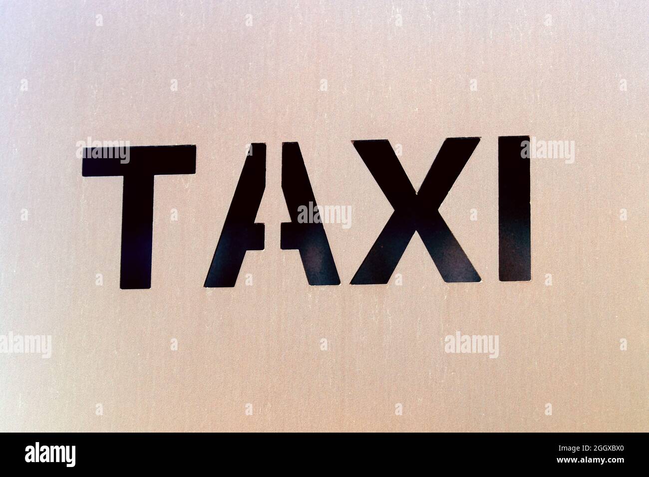 The cut out word taxi on a metallic signpost at a taxi rank Stock Photo ...