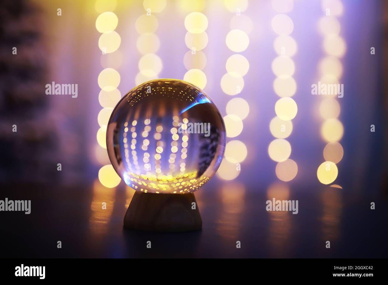 Crystal Ball on the floor with bokeh. Glass ball with colorful bokeh light, new year celebration ...