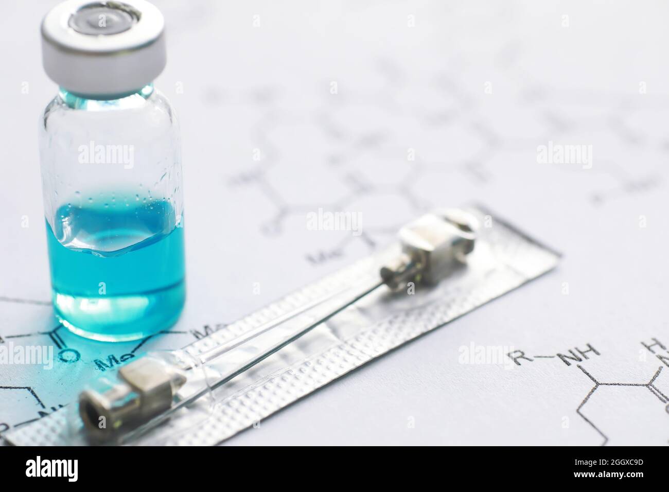 small jars with injection and syringe for injection on blue background ...