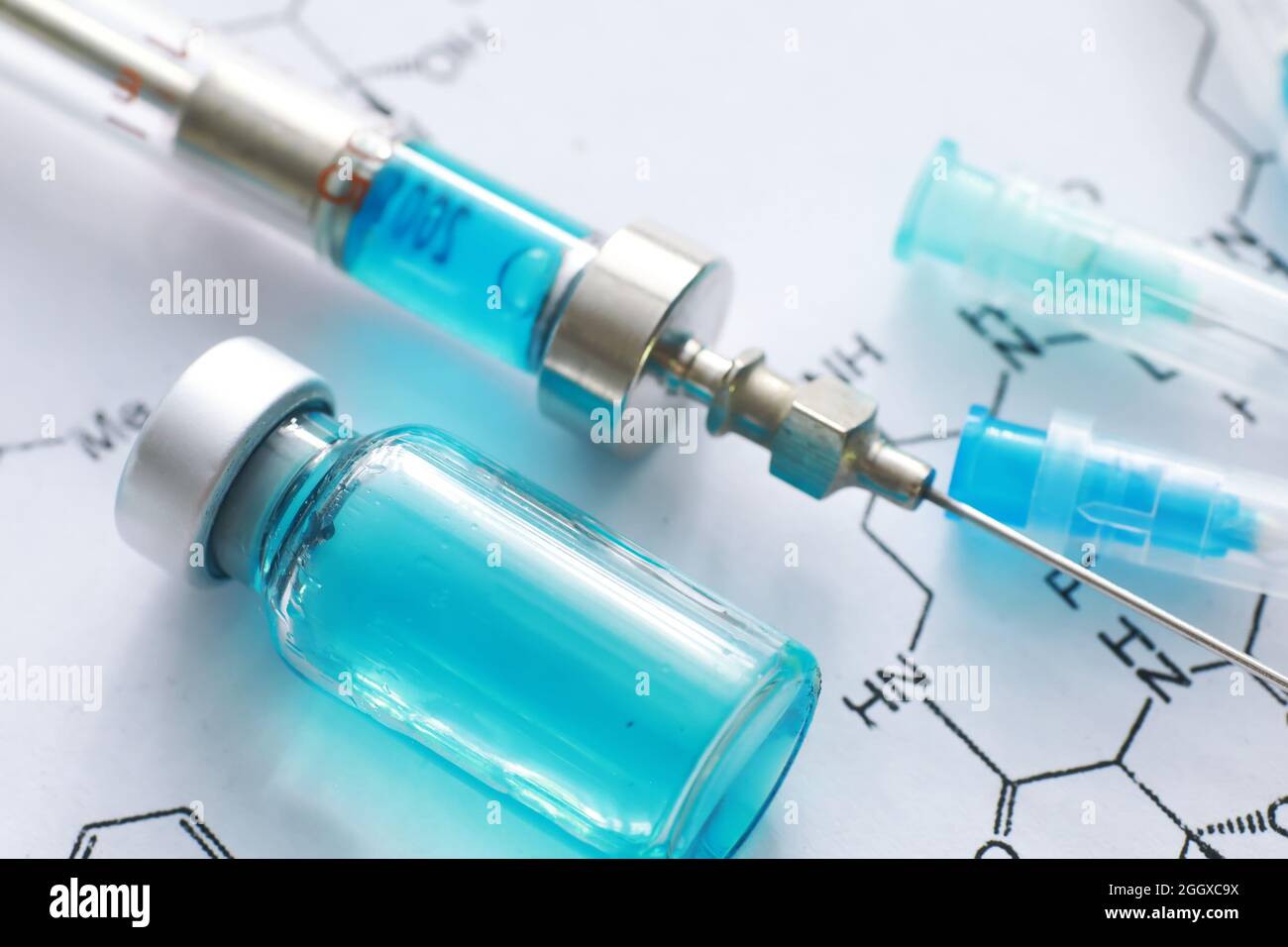 small jars with injection and syringe for injection on blue background ...