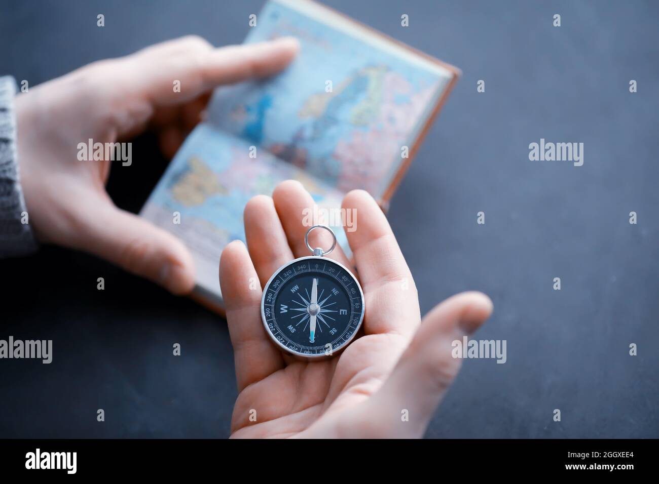 Travel concept. Magnetic compass in the hand. Retro navigator in hand ...