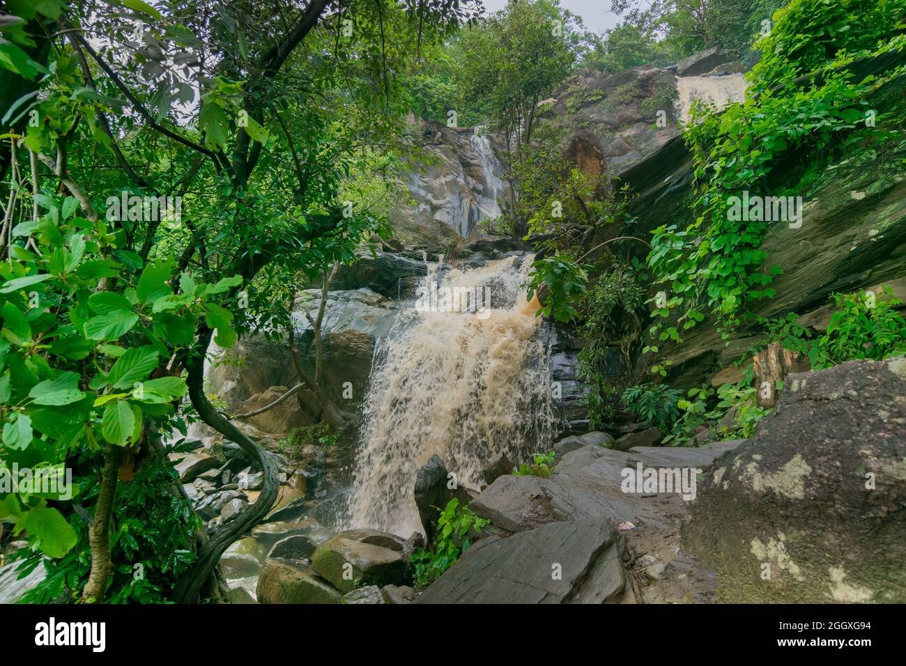 Beautiful Bamni waterfall having full streams of water flowing downhill ...