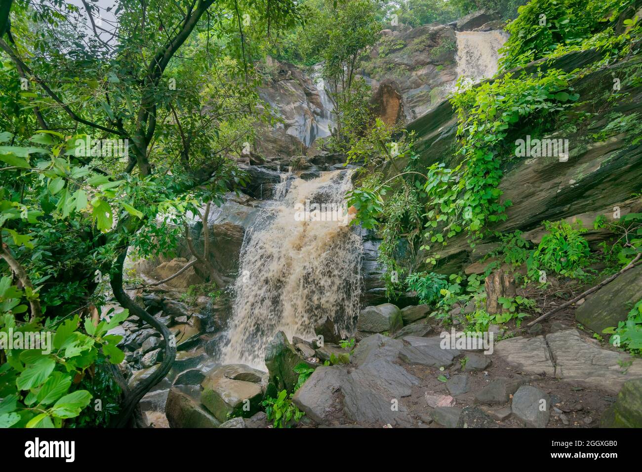 Beautiful Bamni waterfall having full streams of water flowing downhill ...