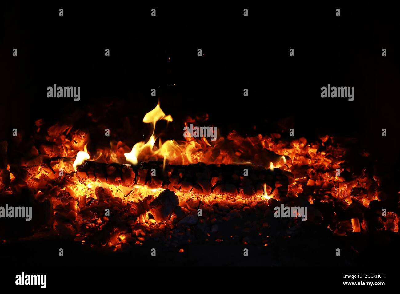 Burning red hot sparks fly from big fire. Beautiful abstract background ...