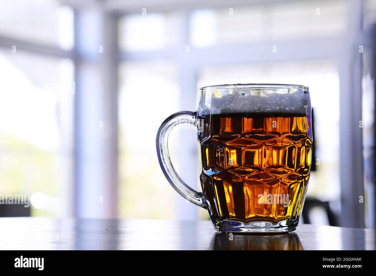 Glass of fresh beer on a wooden table. Lager beer mug on stone table ...