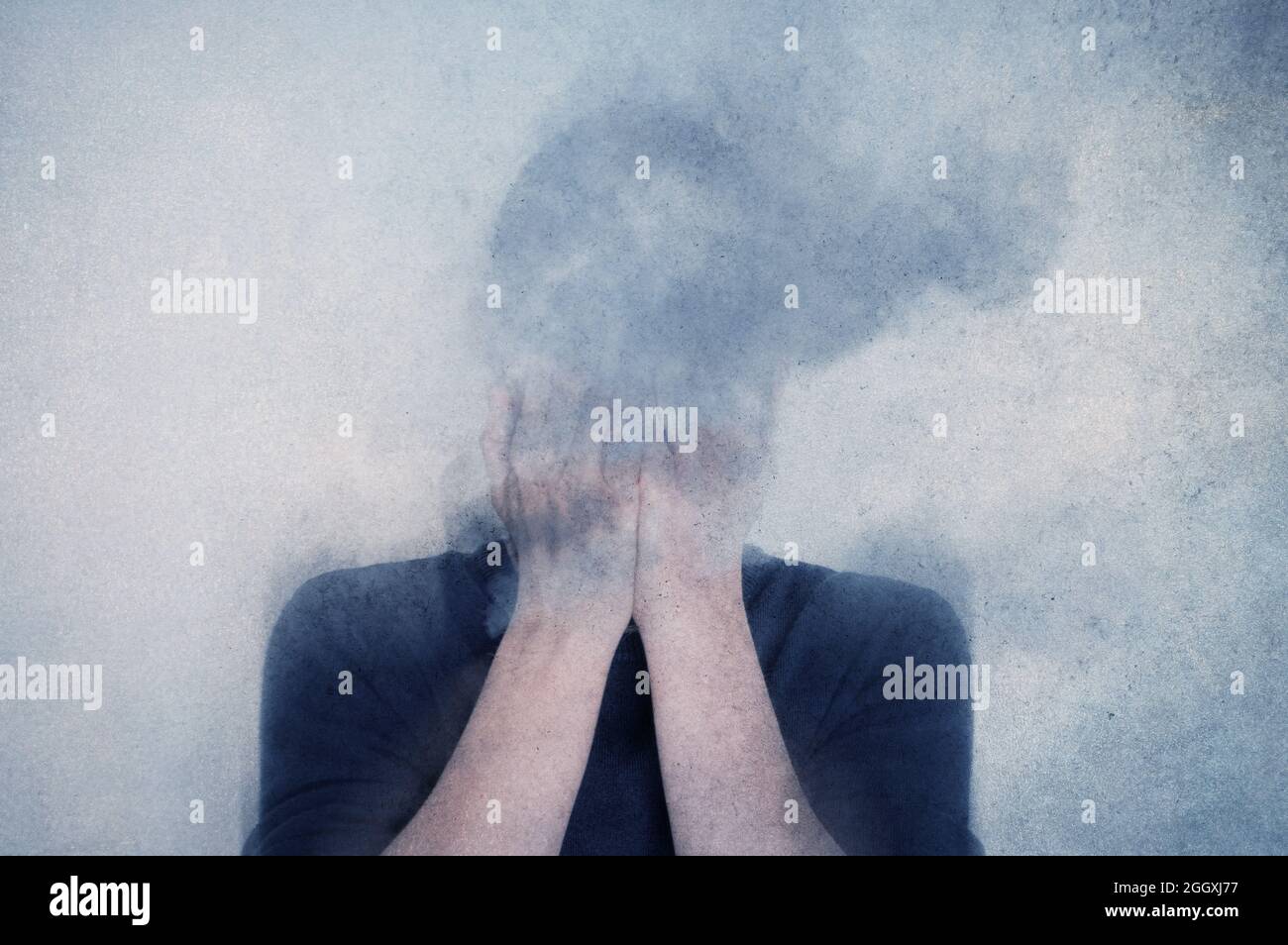 A mental health concept. Of a man with his head in his hands vanishing ...