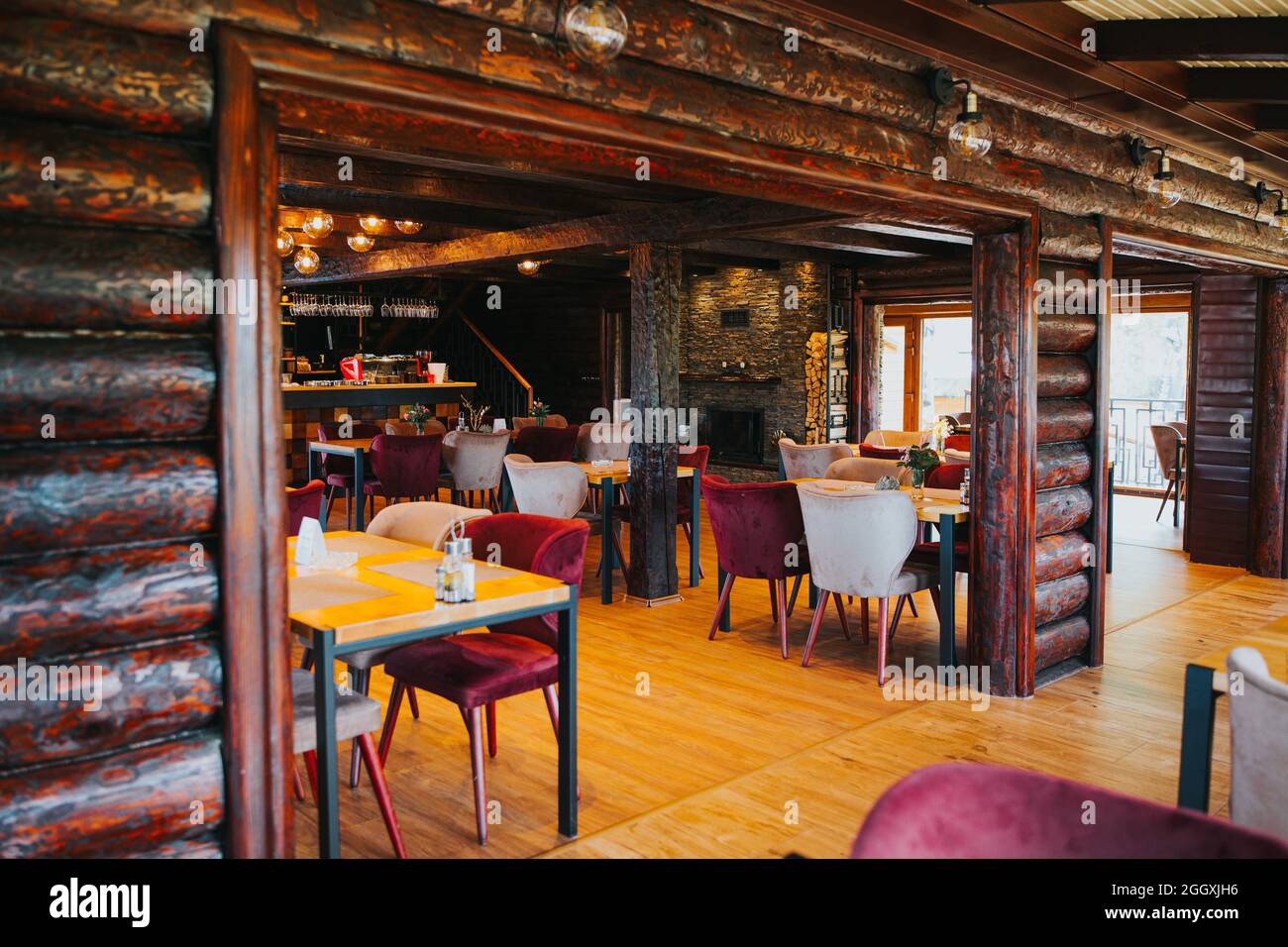 Interior of a restaurant designed with wooden logs and lamps Stock ...