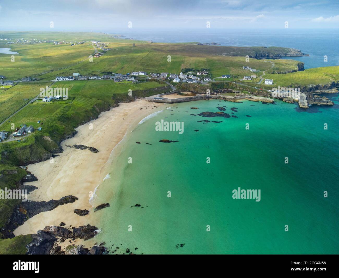 Aerial view from drone of village beach and harbour at Port Ness at ...