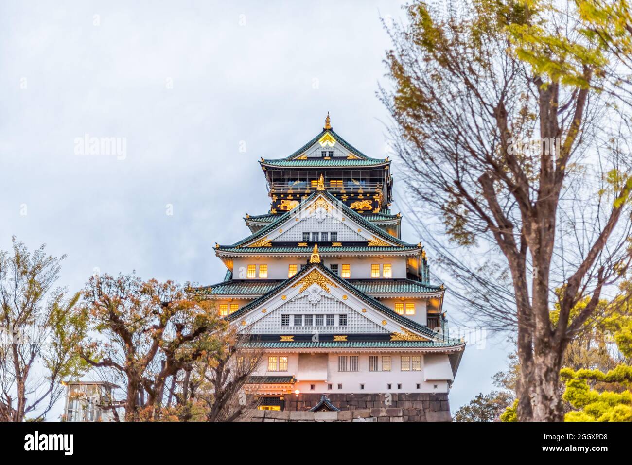 Osaka, Japan castle grounds park in evening with famous historic ...