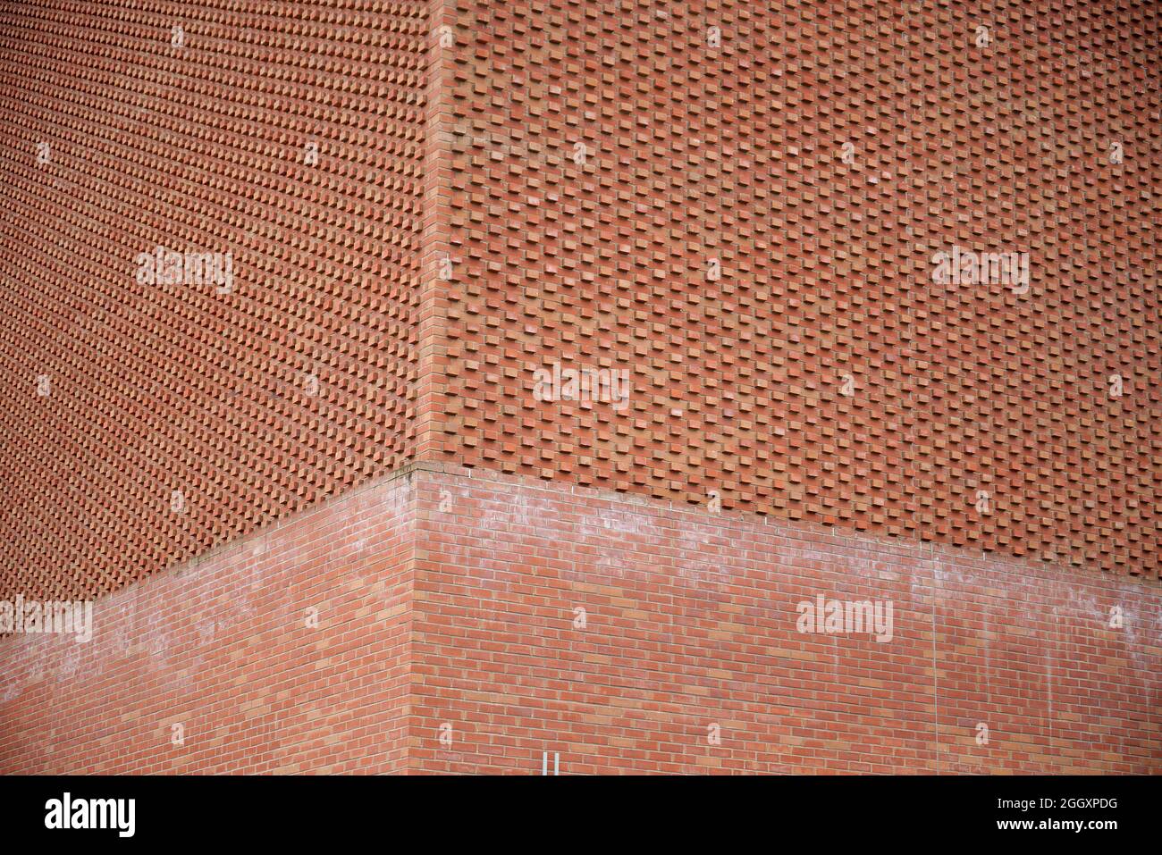 A modern red brick architectural structure with in built pattern or ...