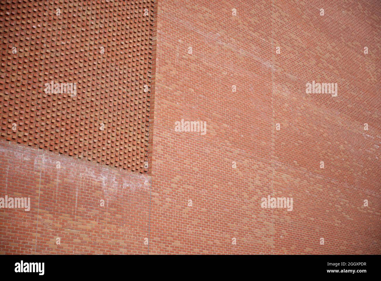 A modern red brick architectural structure with in built pattern or ...