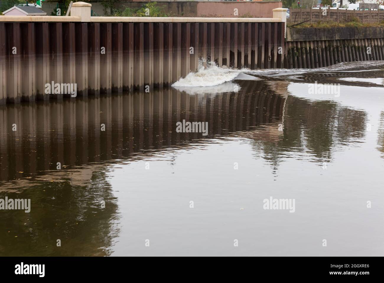 The Mersey Tidal Bore splashing against flood defences opposite Wharf ...