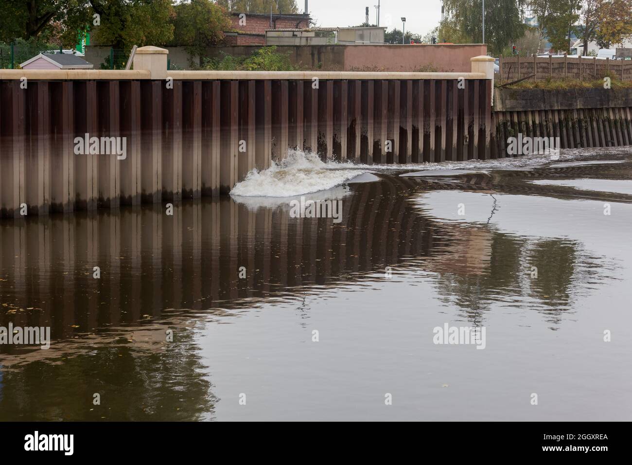 The Mersey Tidal Bore splashing against flood defences opposite Wharf ...