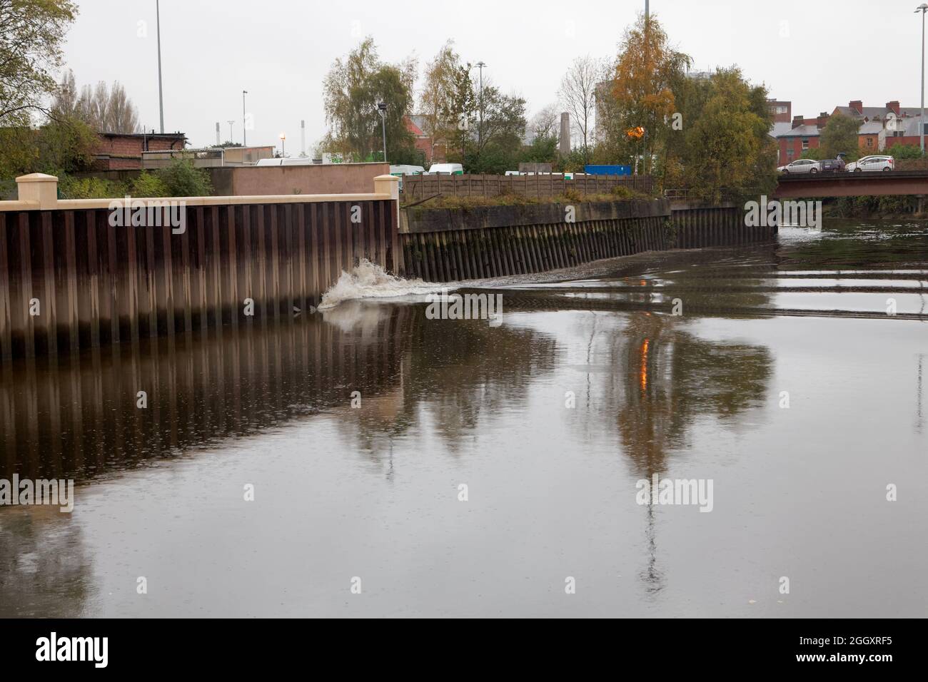 The Mersey Tidal Bore splashing against flood defences opposite Wharf ...