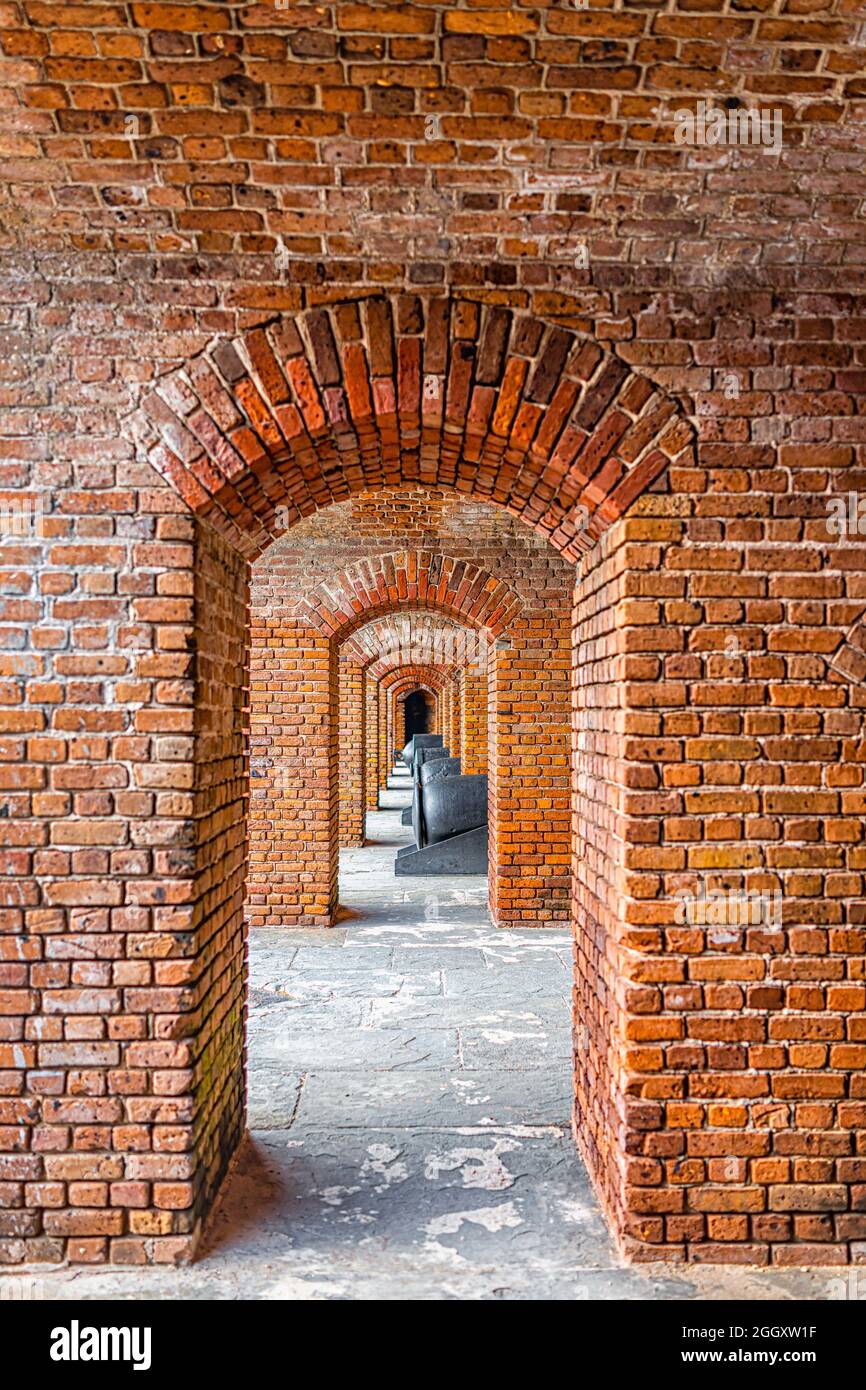 Tunnel archway passage with brick walls and cannon guns at Fort Zachary ...