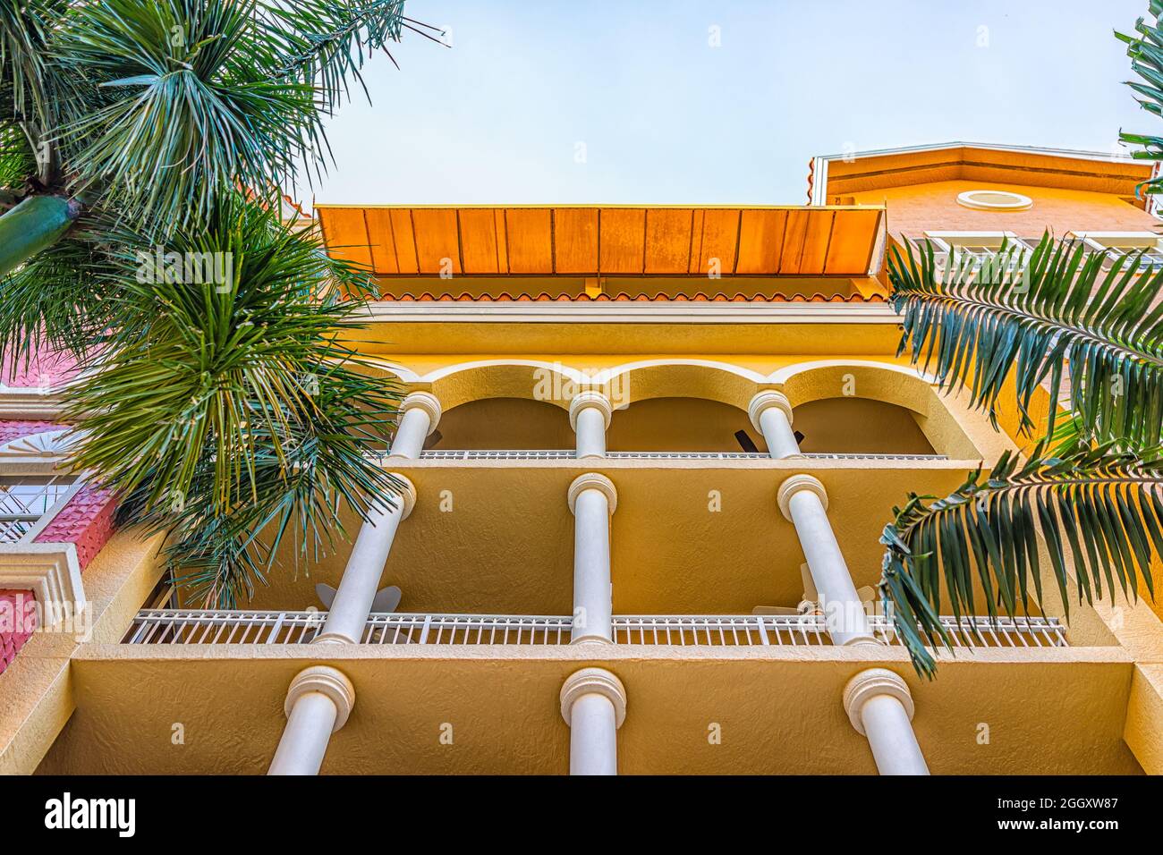 Low angle looking up view on pink red orange and yellow colorful condos ...