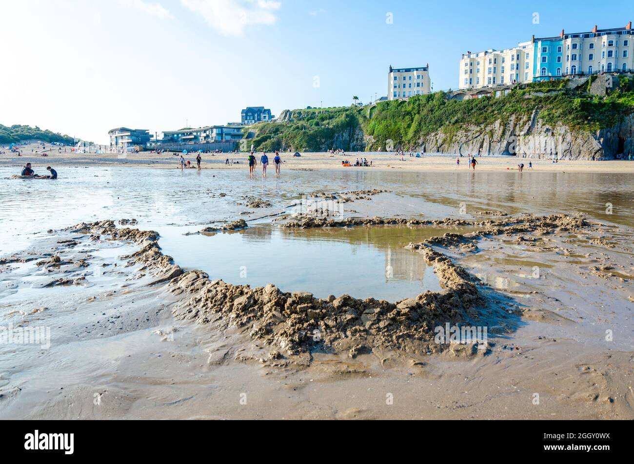 A dam built on Tenby South Beach at low tide has created a pool of ...