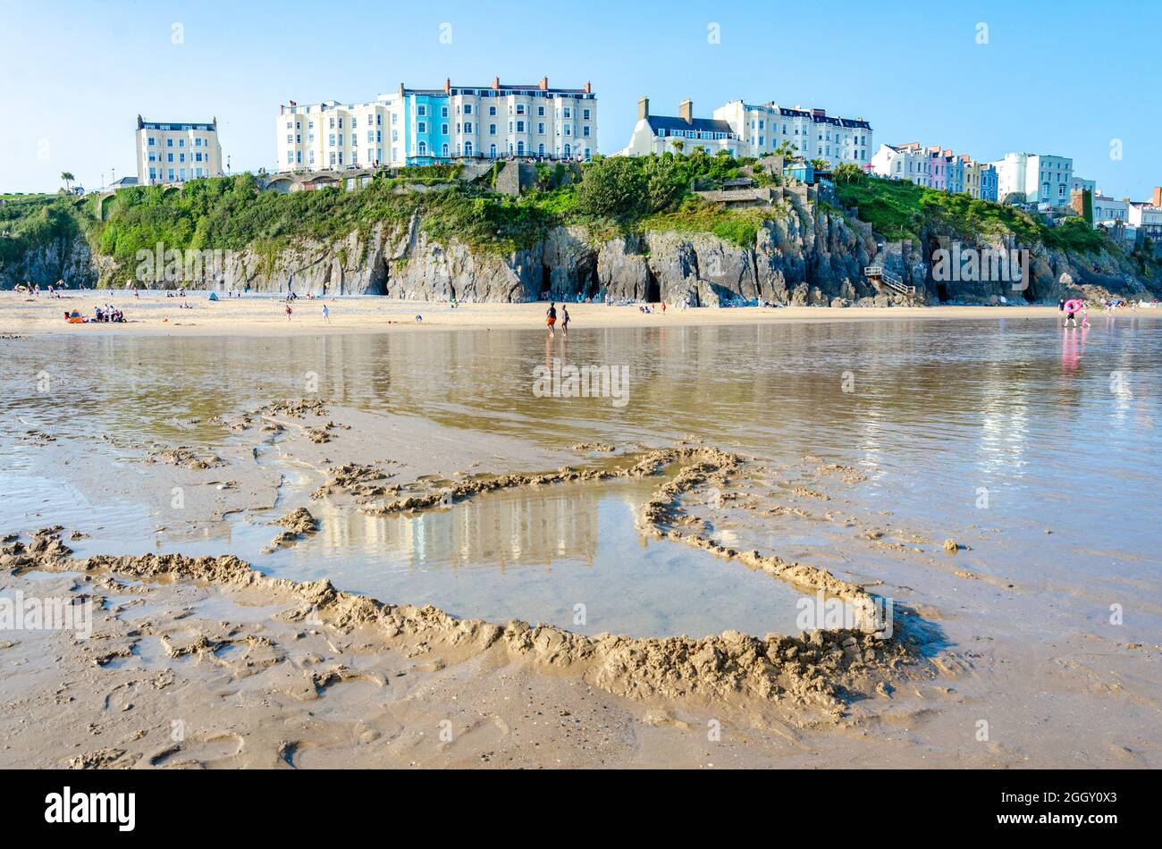 A dam built on Tenby South Beach at low tide has created a pool of ...