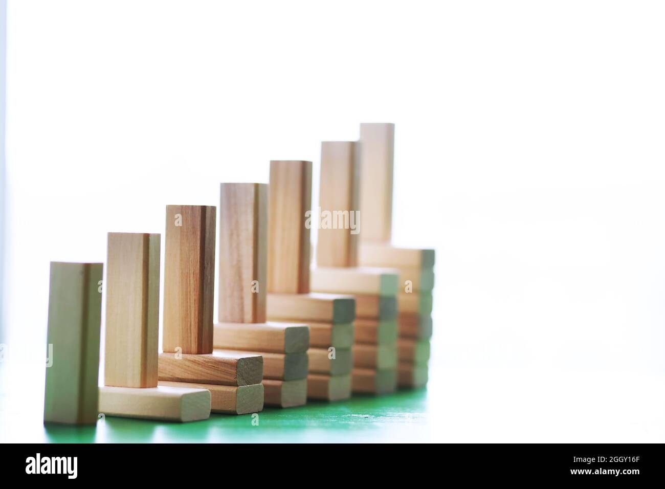 Stick wood block standing on stacked square wood blocks, abstract ...