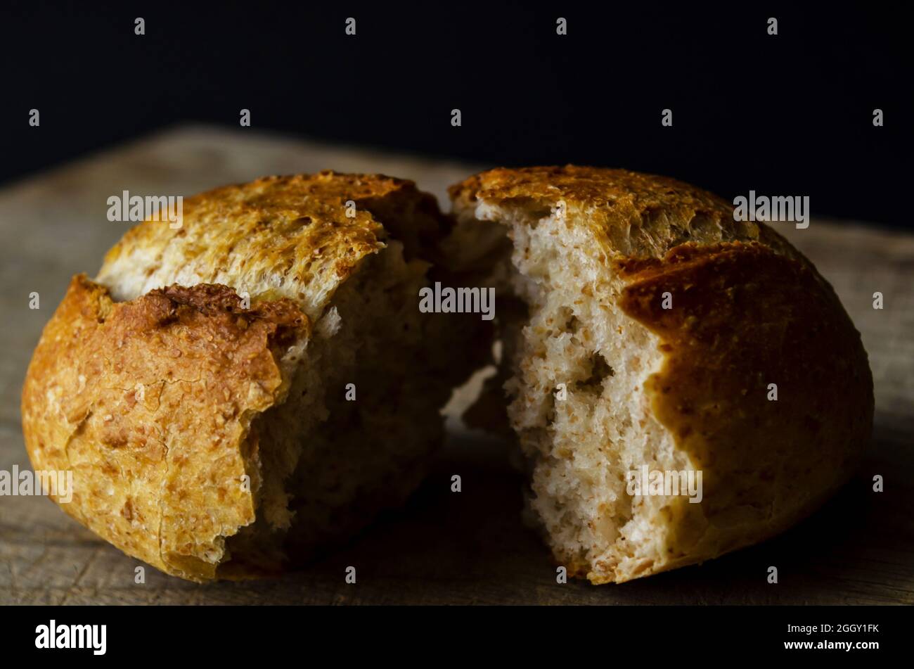 freshly baked buns, broken in half Stock Photo - Alamy