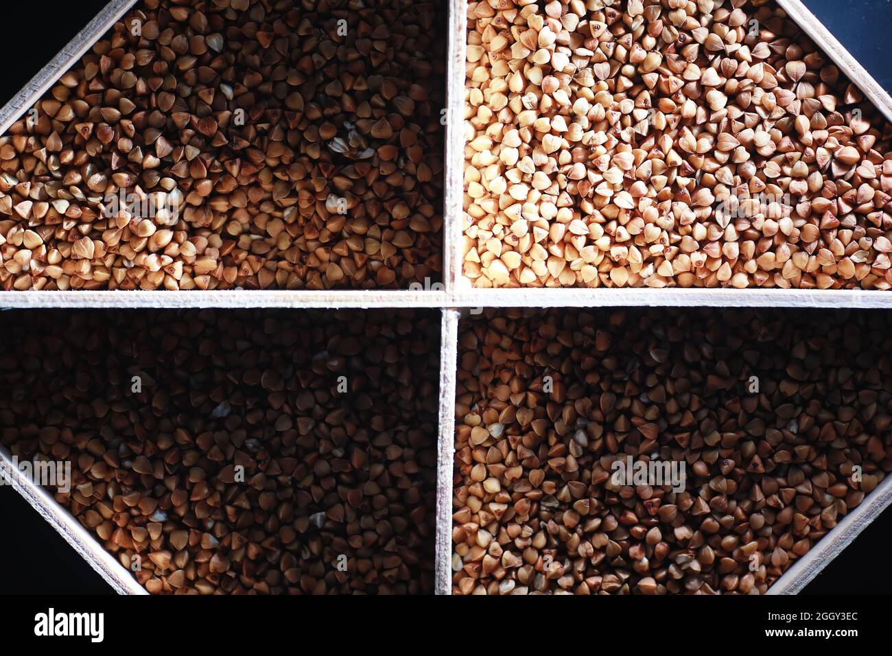 A set of grain cereals. Rice, buckwheat and millet groats in wooden ...