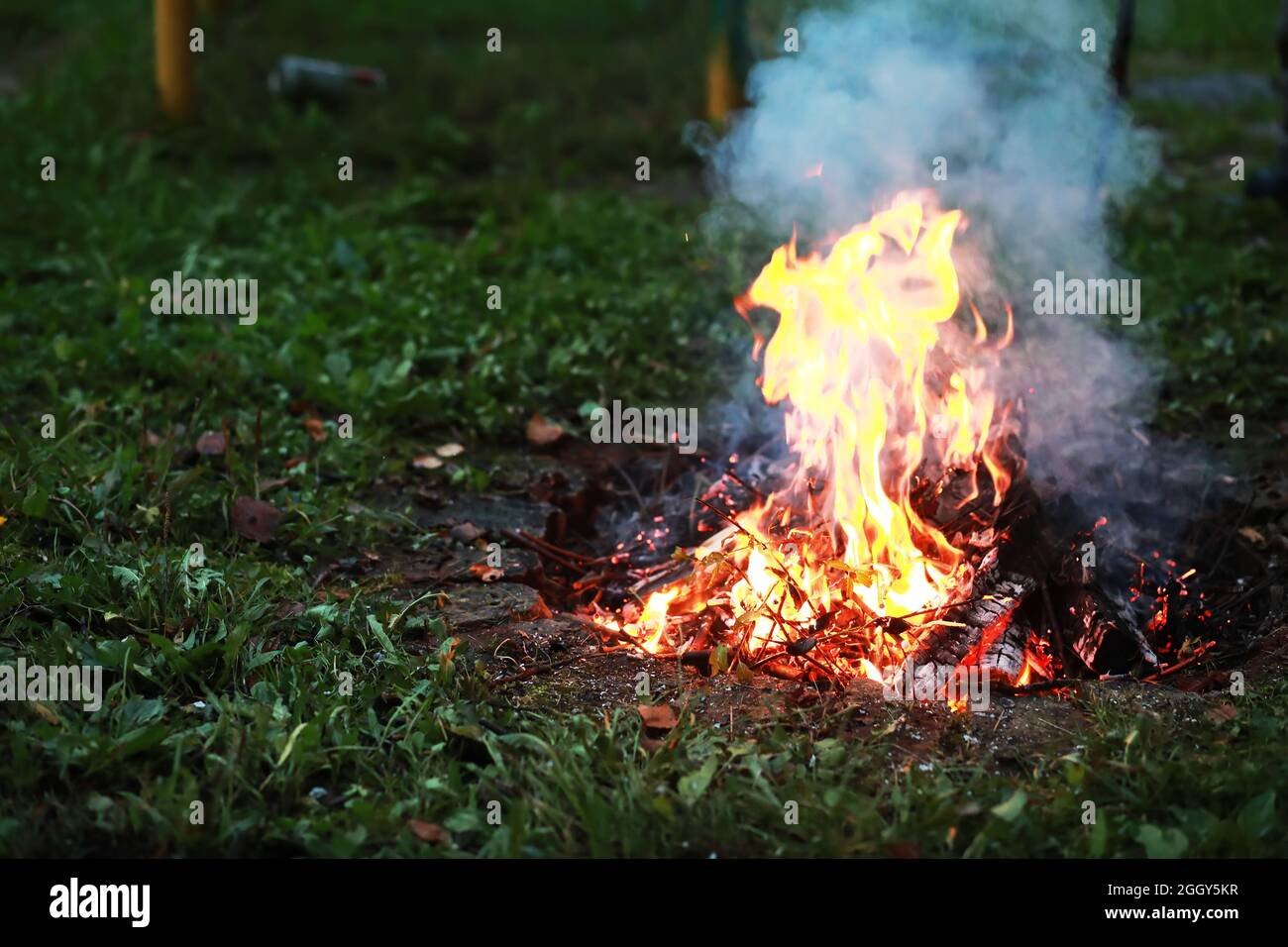 Burning red hot sparks fly from big fire. Burning coals, flaming ...