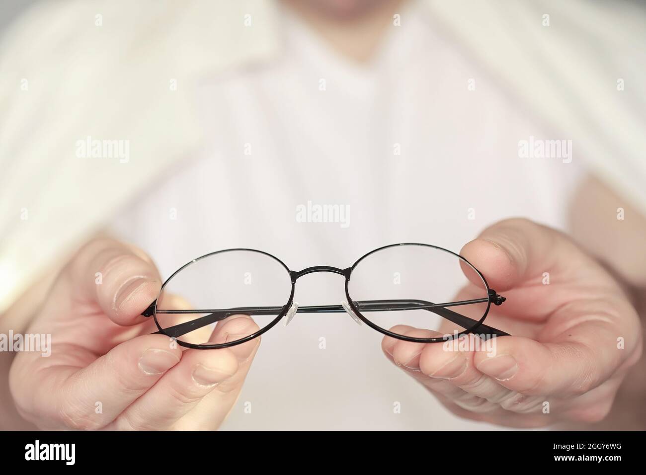 The concept of poor vision. Hold a contact lens and glasses in hand ...