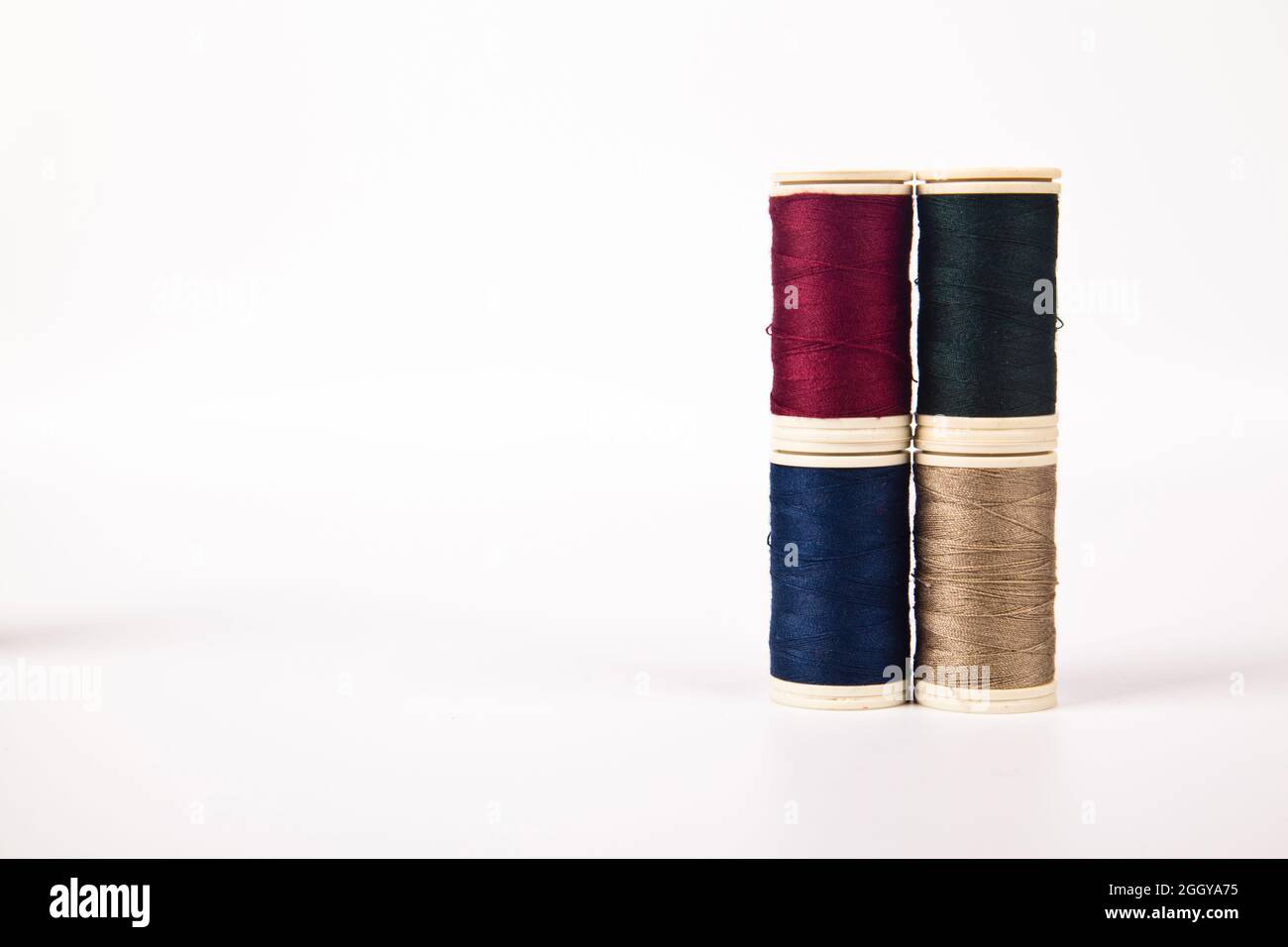 Spools and bobbins of thread for sewing in different colors, isolated ...