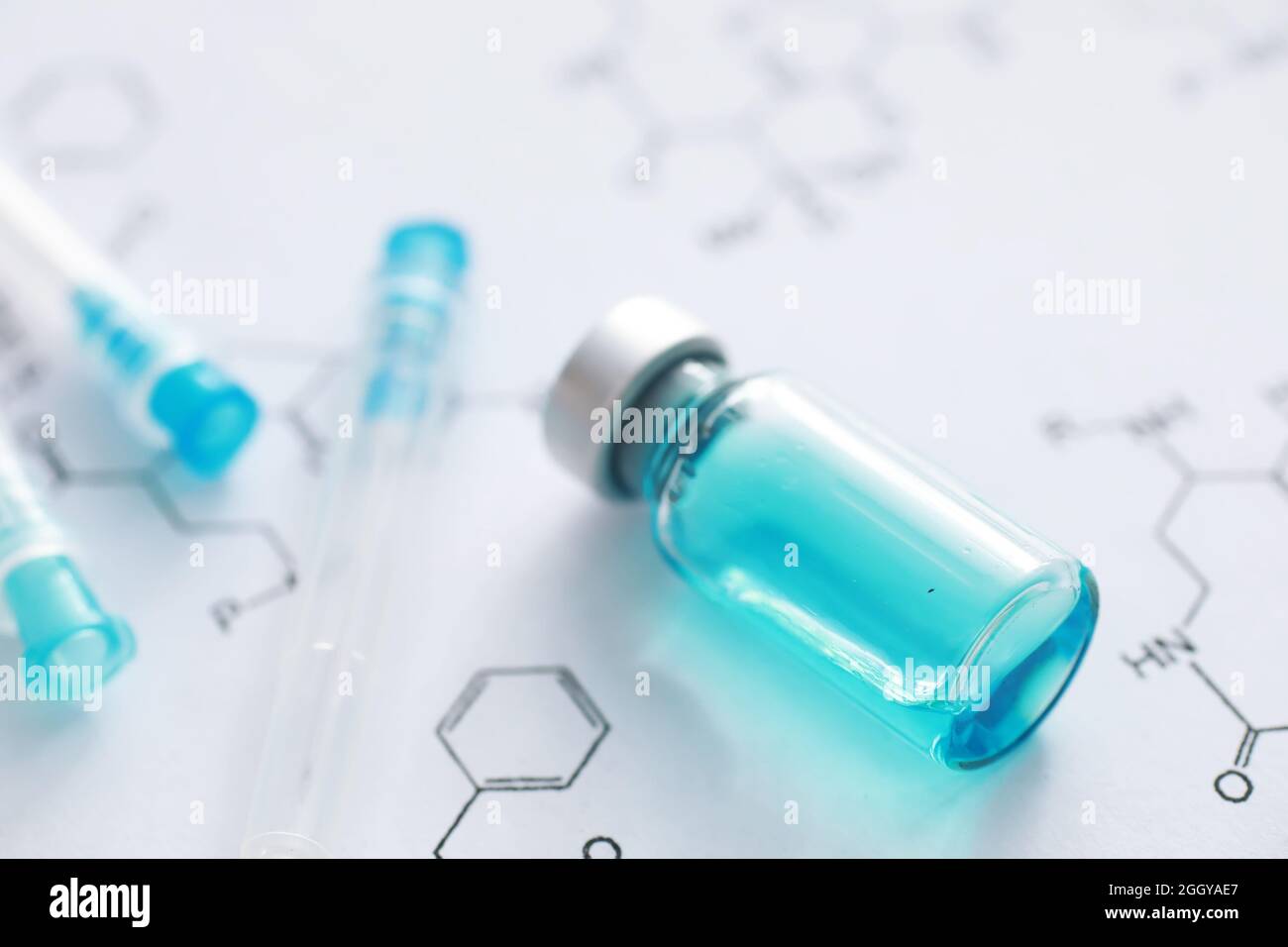 small jars with injection and syringe for injection on blue background ...