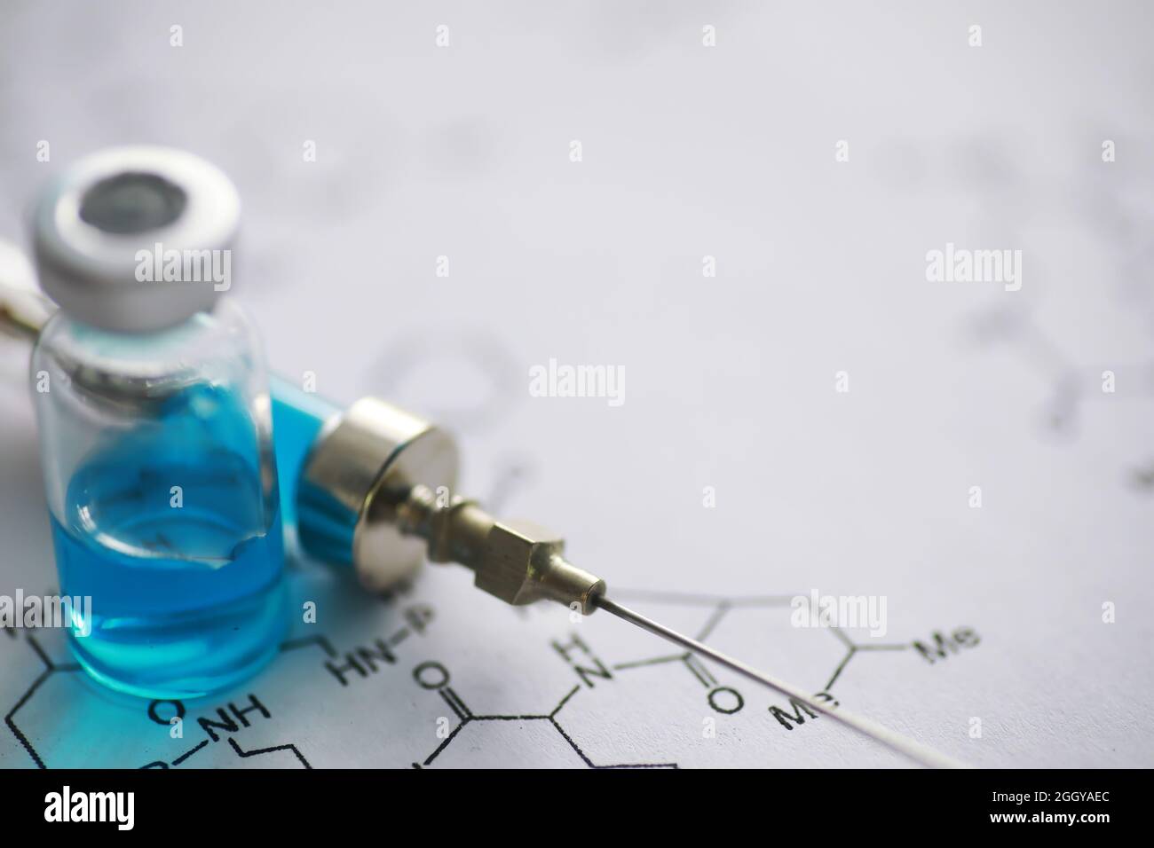 small jars with injection and syringe for injection on blue background ...