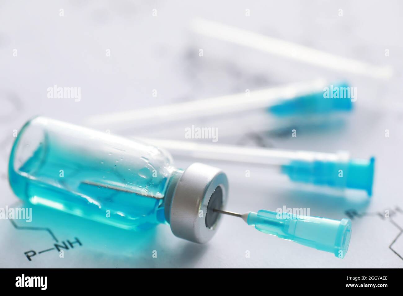 small jars with injection and syringe for injection on blue background ...