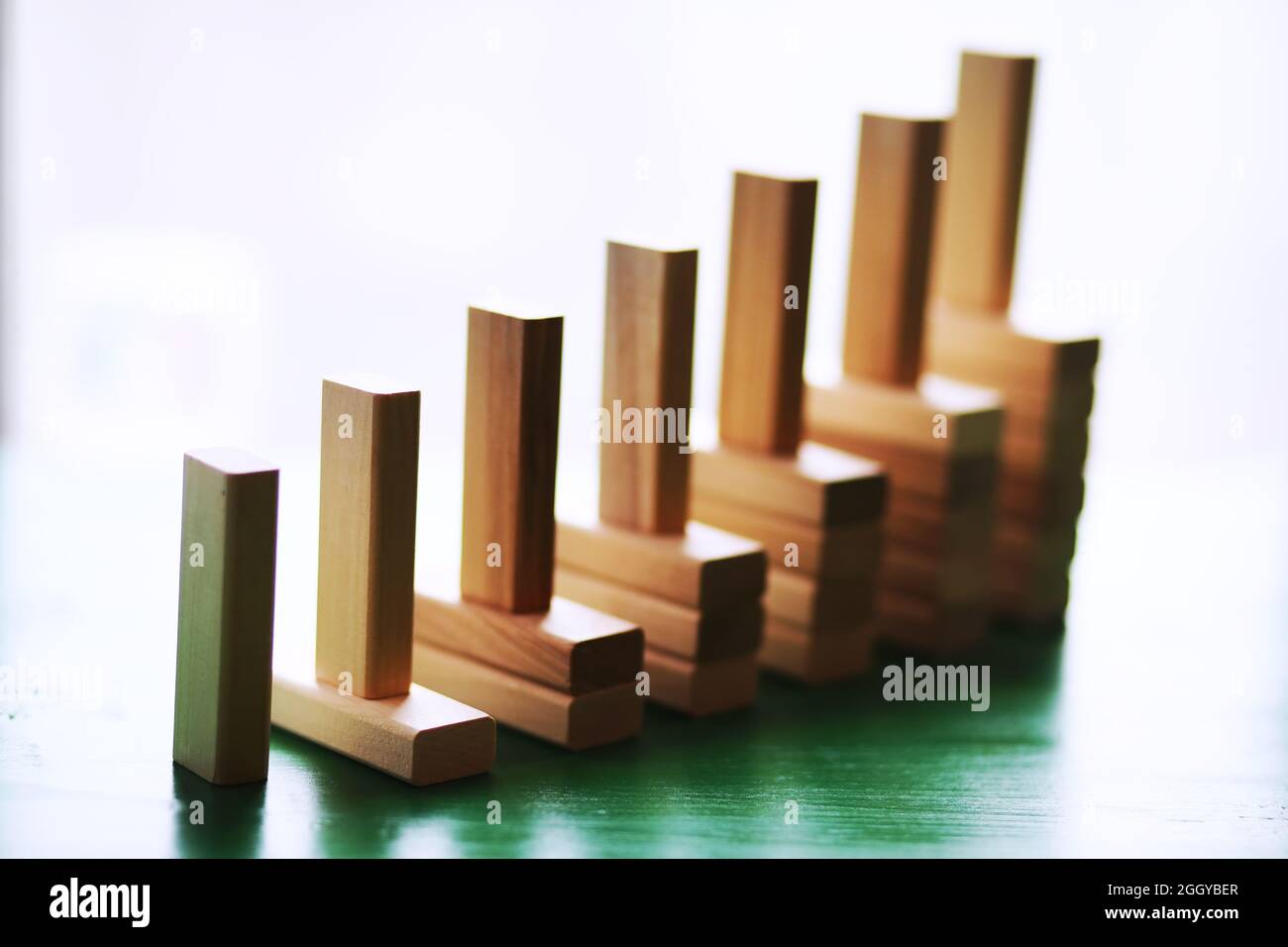 Stick wood block standing on stacked square wood blocks, abstract ...