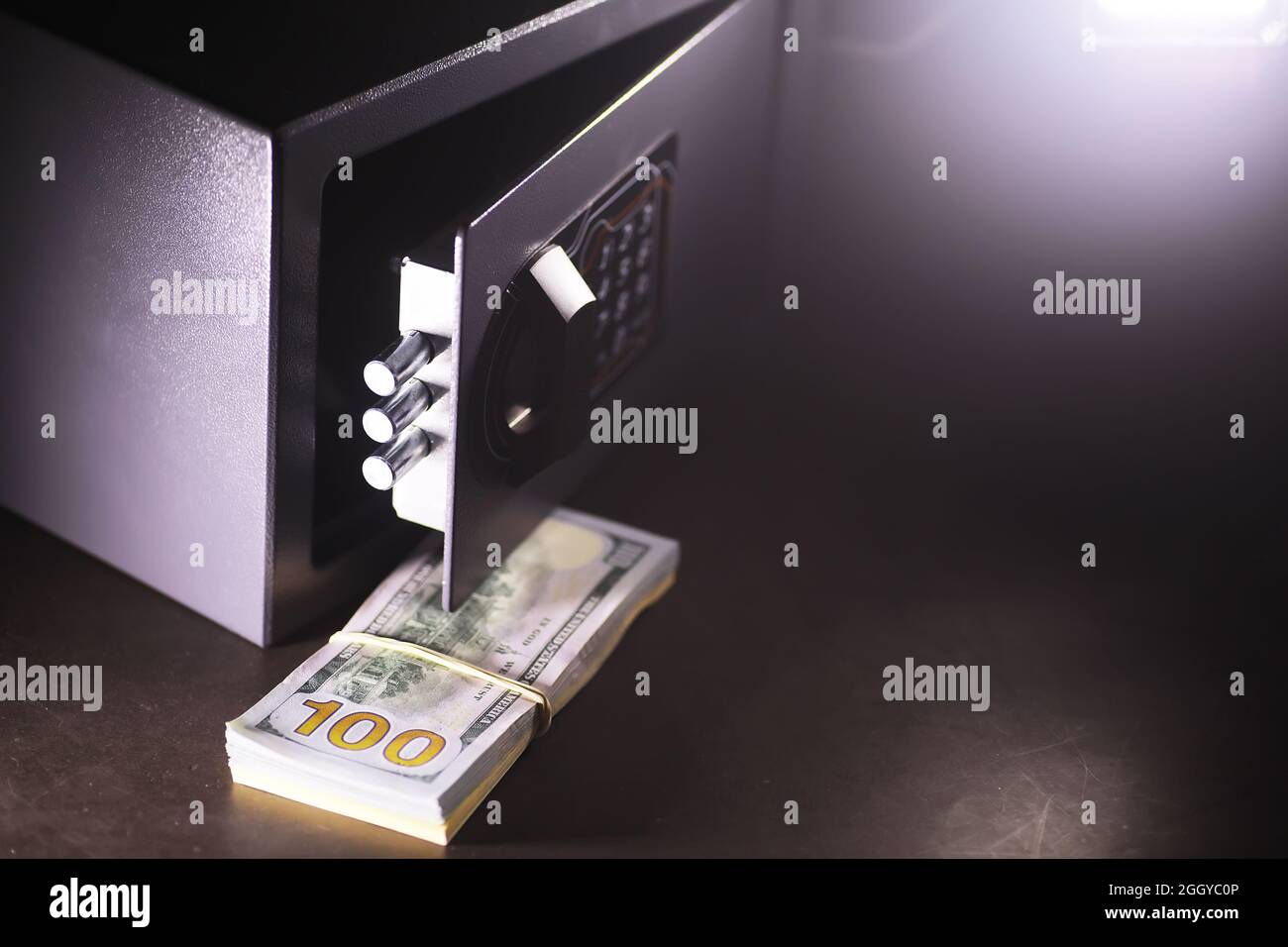 Steel safe with money. Hand putting password in the safety money box in ...
