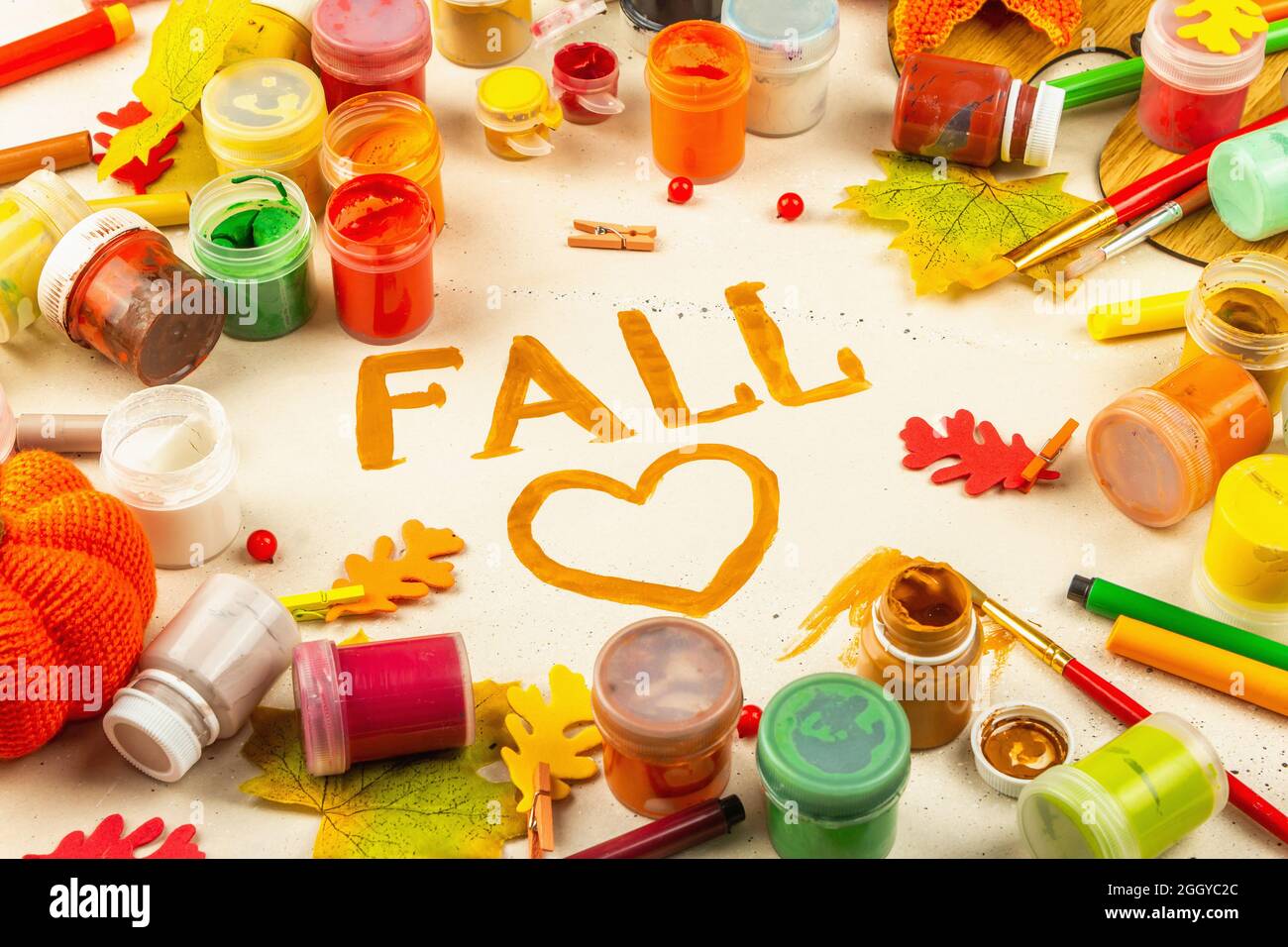 Creative autumn colors composition. Gouache, brushes, paper ...