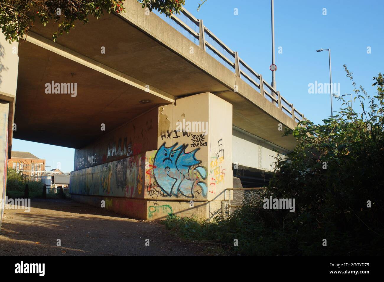 Low angle view of a bridge underpass with graffiti covered walls Stock ...