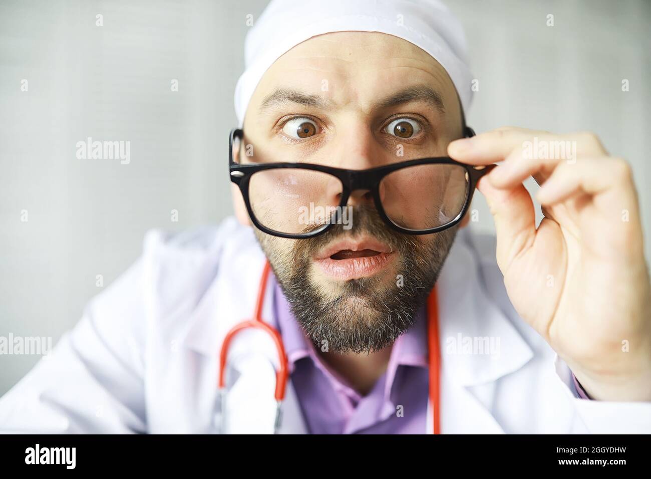 A cross-eyed bearded man is looking into the frame. Eye disease. The ...