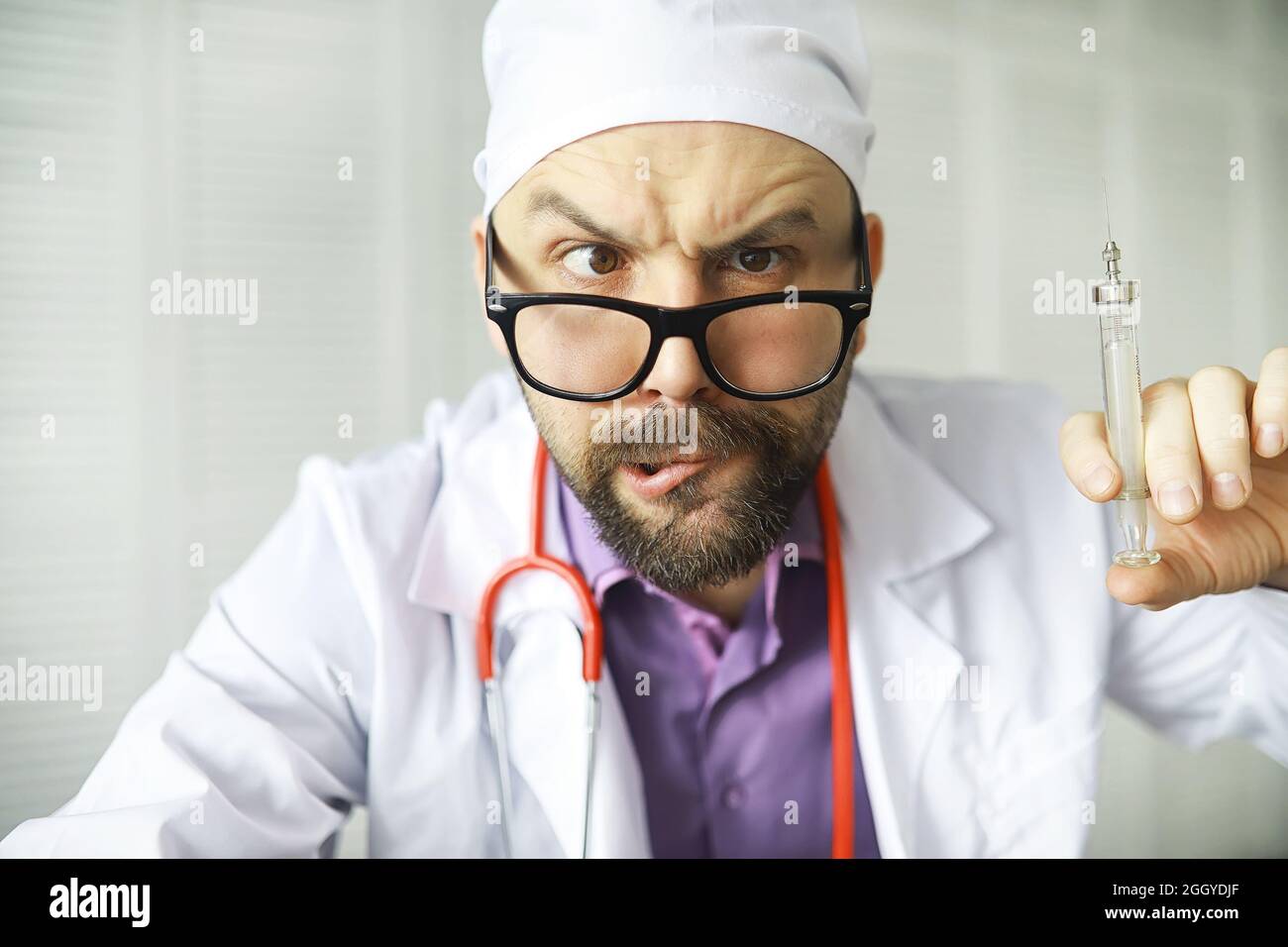 A cross-eyed bearded man is looking into the frame. Eye disease. The ...