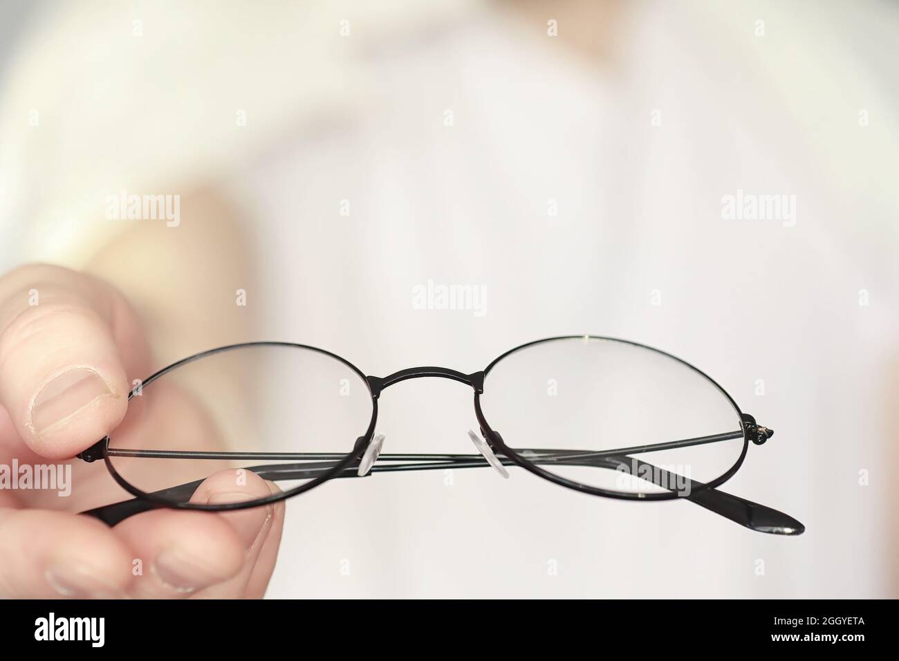 The concept of poor vision. Hold a contact lens and glasses in hand ...