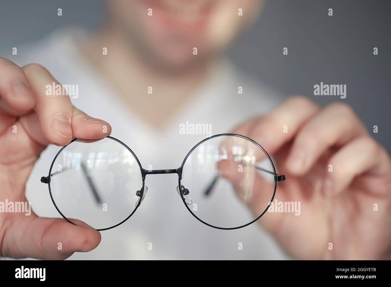 The concept of poor vision. Hold a contact lens and glasses in hand ...